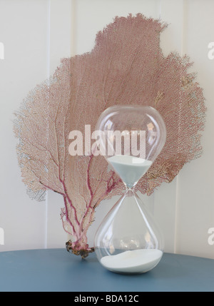Beach still life with sand timer Stock Photo - Alamy