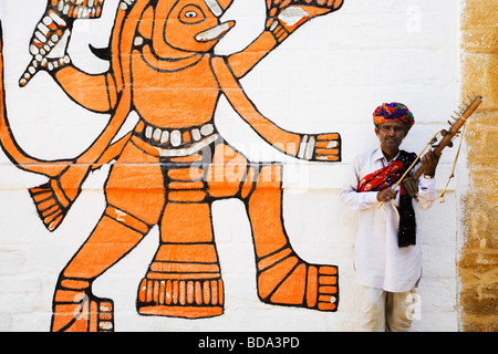 Mid adult man playing sarangi in a palace, City Palace, Jaipur ...