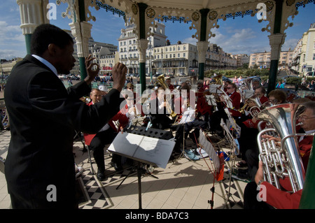 A black conductor leads the Patcham silver band in a concert on ...