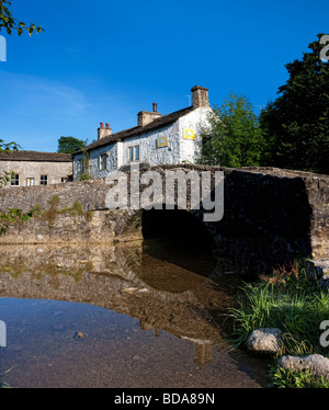 Malham Village, view in summer of the vintage signpost at the centre of ...