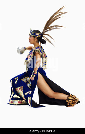 Side profile of an Aztec dancer wearing stage costume and performing ...