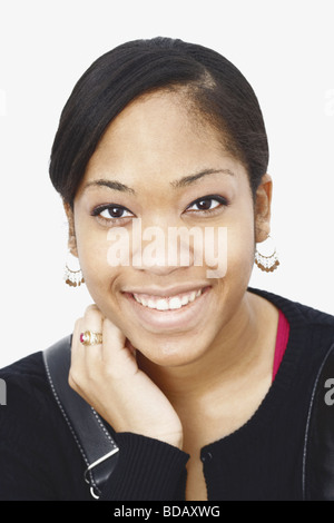 portrait of young cheerful ethnicity woman in dress near roses in a ...