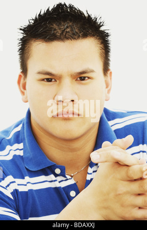 Portrait of a young man looking serious Stock Photo - Alamy