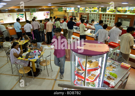 Indian customers queue for fast food for sale at the counter in ...