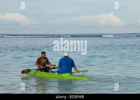 Samoan men in outrigger canoe, in lagoon at Manase, Savai'i Island ...