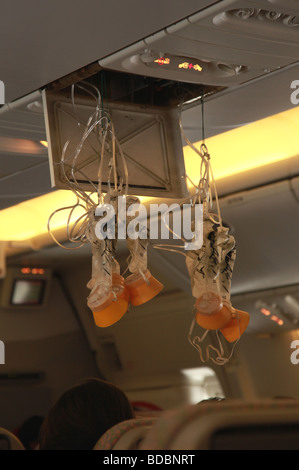 Oxygen masks on airplane Stock Photo - Alamy