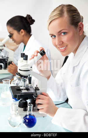 Young Asian female doctor using tablet device reviewing medical ...