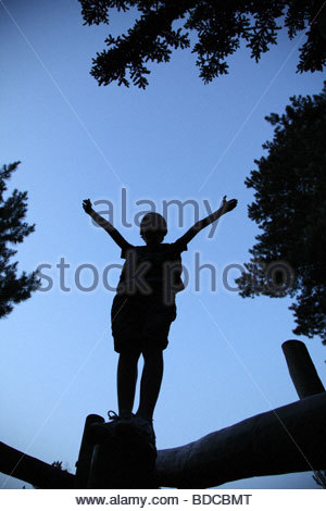 Kids silhouette on climbing frame in playground with London Eye in ...