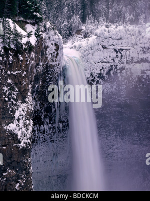 Majestic frozen waterfall with icy cliffs and snow-covered rocks ...