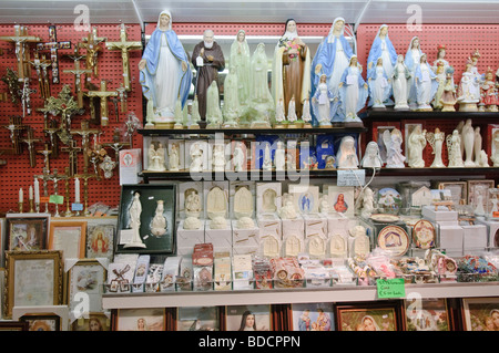 Religious icons, holy water and statues on sale at souvenir shops at ...
