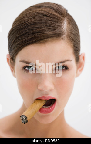Portrait, smoking and woman in fashion on chair, studio and wink in ...