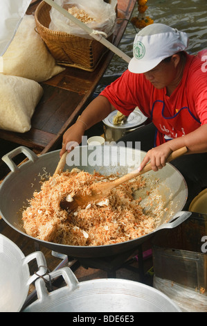 vendor making mee krop noodles at a floating market in Bangkok Thailand ...
