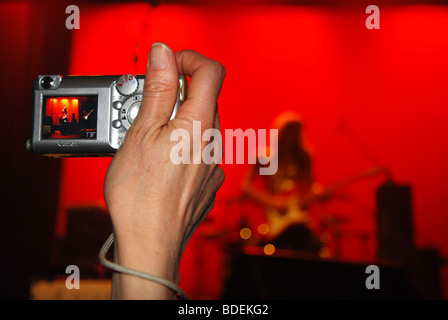 spectator taking snapshot at rock concert with digital camera Stock ...