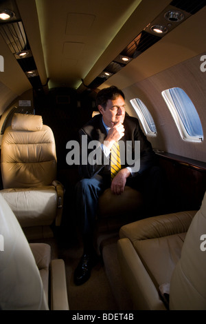 Businessman sitting in small private jet plane Stock Photo - Alamy
