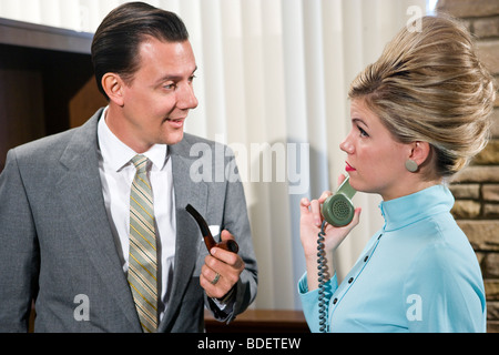 Vintage portrait of young secretary with beehive sitting in office ...