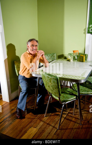 Elderly man sitting at table full of pills boxes Stock Photo - Alamy