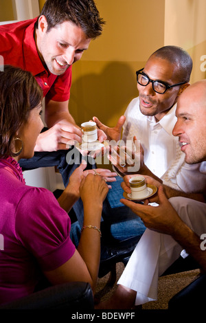 Diverse group of friends enjoying some coffee together in a restaurant ...