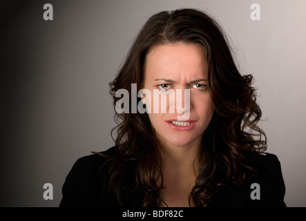 woman with angry expression grinding teeth Stock Photo - Alamy