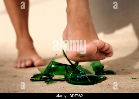 Woman´s foot about to step on broken glass Stock Photo - Alamy