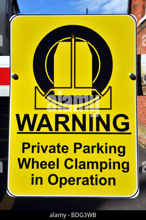 Wheel clamping warning sign Stock Photo - Alamy