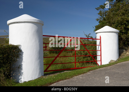 traditional irish field entrance with stone pillars and wrought iron ...