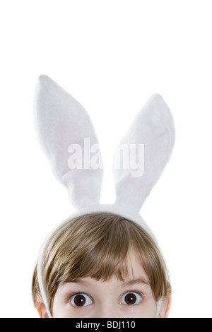 amazed easter child in bunny ears and bow tie on yellow background ...