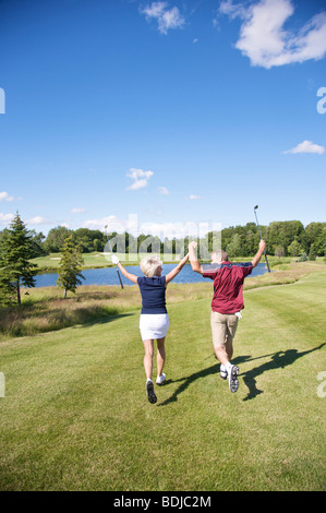Excited lady golfer standing Stock Photo - Alamy