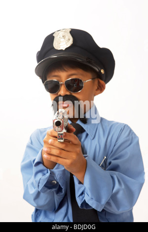 Asian boy aim a fake gun made with barcode scanner, studio shot, on ...