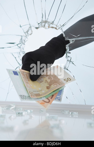A window with a hole broken through the glass, night Stock Photo - Alamy