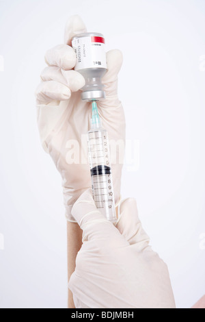 Female medical professional preparing hypodermic syringe Stock Photo ...
