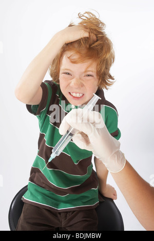 hand holding hypodermic needle with red fluid Stock Photo - Alamy