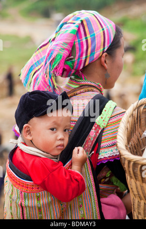 Flower Hmong woman carrying baby on her back, Bac Ha Sunday Market, Lao ...