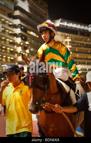 Horse racing jockey in the parade ring Stock Photo - Alamy