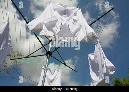 Clothes blowing in the wind. Shirts on a washing line on a windy day ...