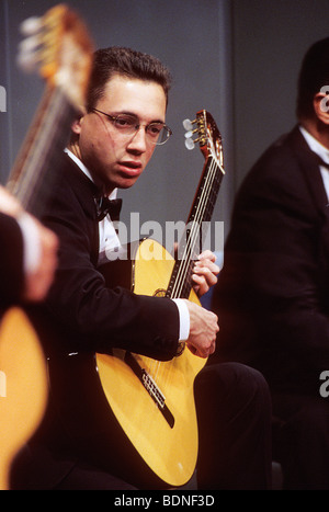 guitar ensemble orchestra Spanish instrument strum pick fingers serious ...