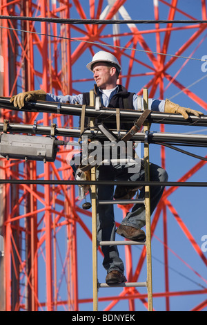 Cable lineman climbing a ladder to repair transmission line Stock Photo ...