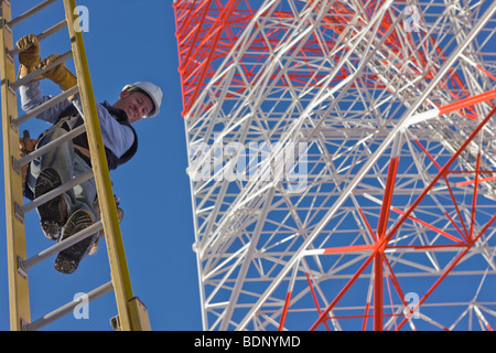 Man climbing down a ladder Stock Photo - Alamy