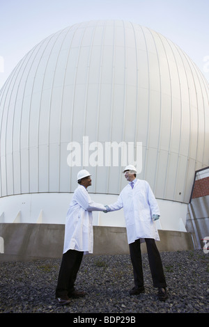 Two scientists shaking hands Stock Photo - Alamy