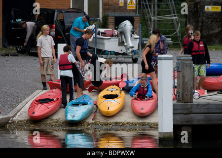 young canoes canoeists launching boat slipway river Medway allington ...