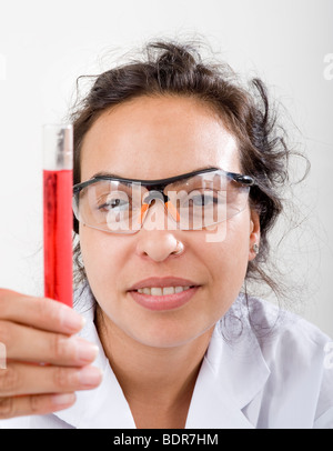 Young beautiful hispanic woman scientist holding plant with tweezers at ...