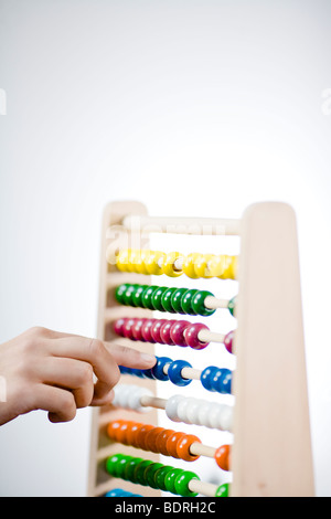 Hand using a color abacus Stock Photo - Alamy