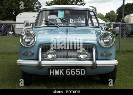 Classic light Blue Triumph Herald open top motor car parked on seafront ...