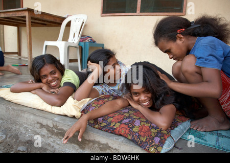 TIMOR LESTE Girls searching for lice in each other's hair, Topu Honis ...