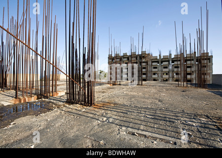 Steel struts, steel wire on the roof of unfinished hotel building ruins ...