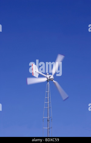 A wind turbine (windmill) generates electricity on a windy day in ...