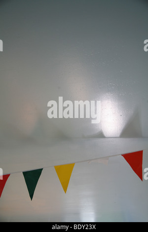 Colorful flags hanging from the ceiling Stock Photo - Alamy