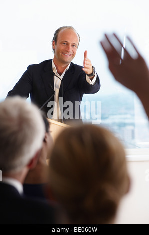 Rear view of a young man pointing upwards Stock Photo - Alamy