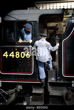 A driver and a fireman on a steam locomotive on the Strathspey Railway ...