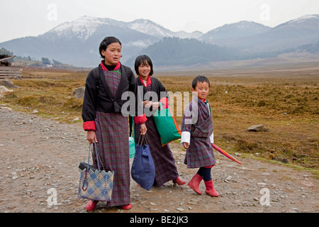 Young Bhutanese boys wearing traditional striped gho (robe) in Nimshong ...