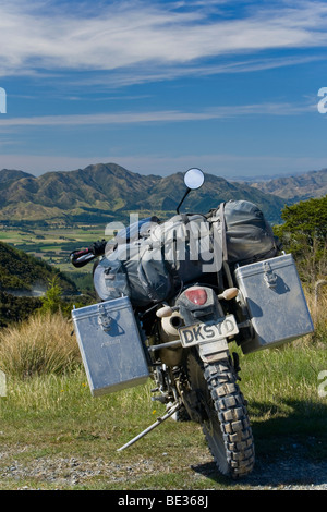 Heavily packed motorcycle in front of a lake behind a rainbow,O higgins ...